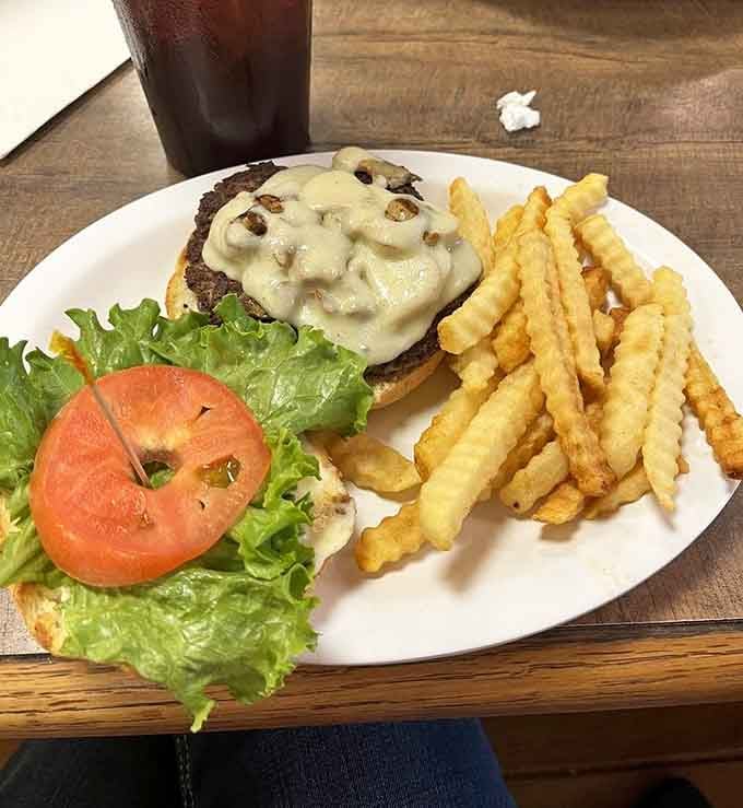 A mushroom-smothered burger with waffle fries is the kind of indulgence that makes diets wait until tomorrow.
