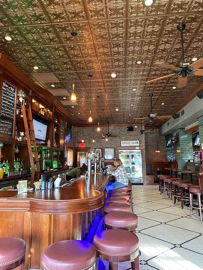 That gorgeous curved bar with tin ceiling tiles overhead creates the perfect spot for conversation and cold beer.