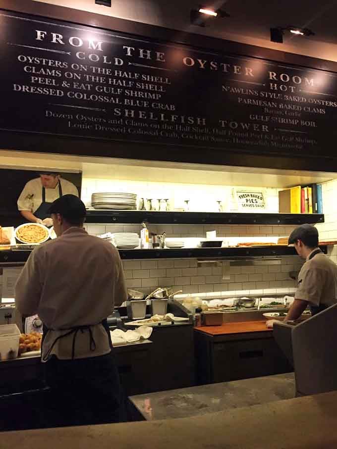 The oyster bar station showcases fresh shellfish preparations, where skilled hands turn ocean treasures into culinary art daily.