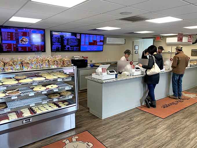 Customers contemplating their options at the counter, facing the age-old question: pie now or pie later? Answer: both.