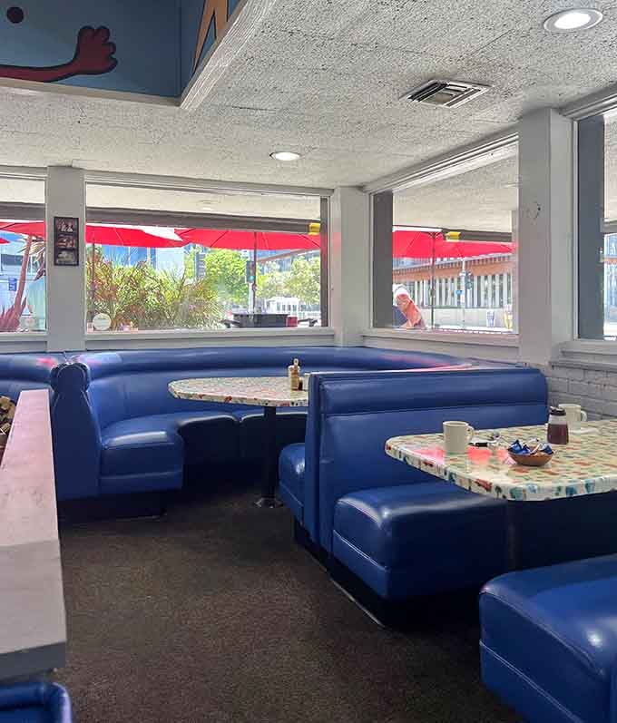 Those blue booths have witnessed countless breakfast victories and a few noble defeats against giant pancakes.