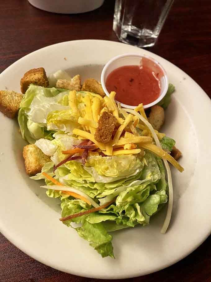 Fresh greens with crispy croutons and shredded cheese prove that even the opening act deserves a standing ovation at this establishment.