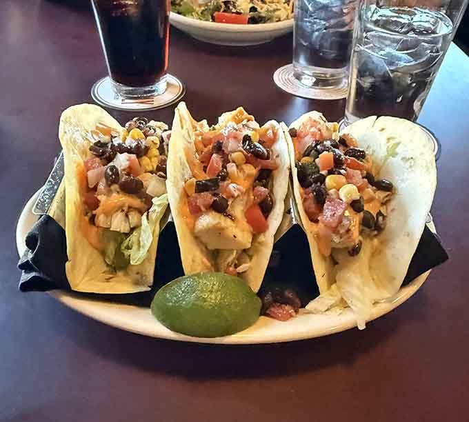 Three tacos loaded with mahi mahi and toppings that make every bite a little fiesta in your mouth.