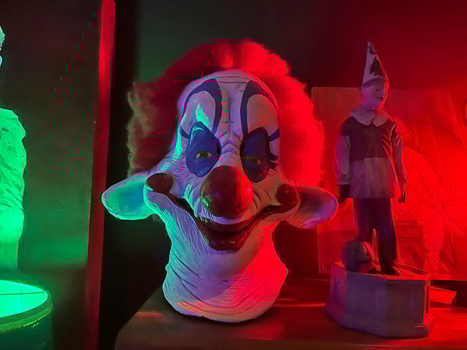 Carnival clown heads glow with neon intensity, celebrating sideshow culture's colorful and slightly terrifying legacy.