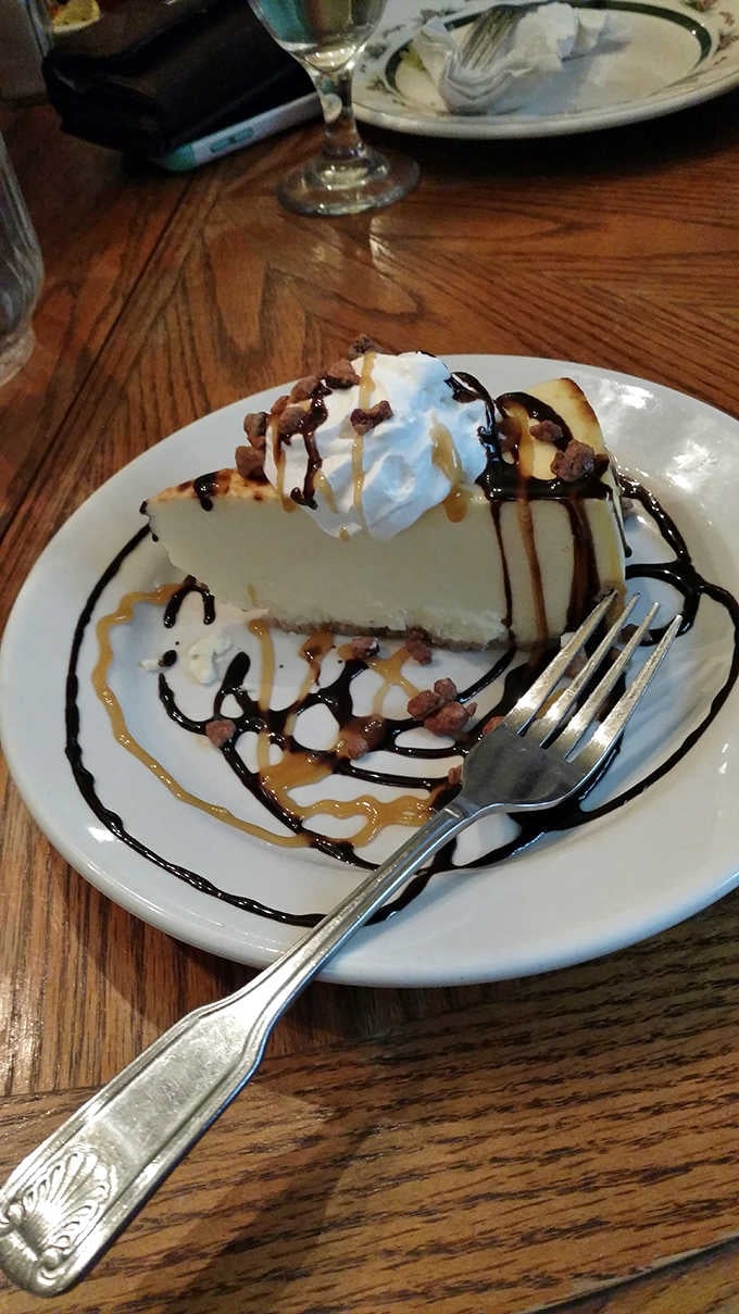 Cheesecake drizzled with caramel and chocolate, topped with whipped cream and bacon bits&mdash;because why choose between sweet and savory?