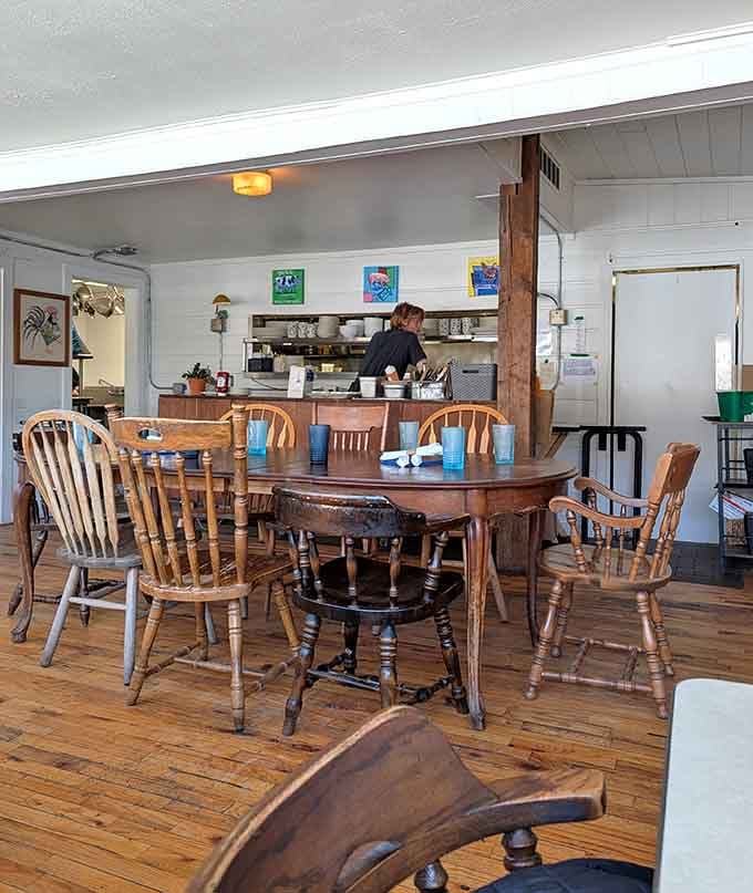 Mismatched wooden chairs and tables create that authentic, lived-in feel that makes you want to stay awhile.