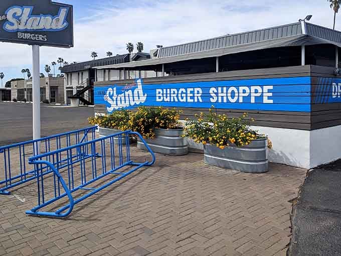 Blue bike rack, planters with flowers, and that retro vibe: details that show someone actually cares.
