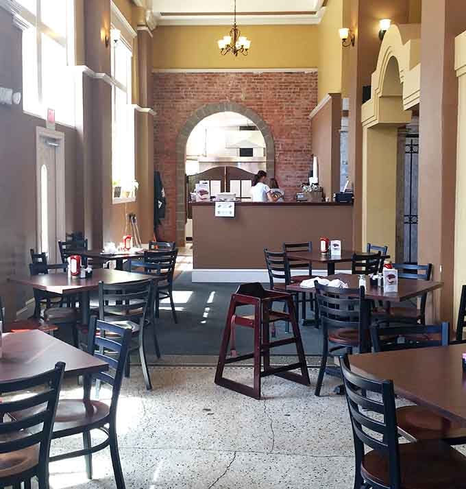 Exposed brick, arched doorways, and plenty of seating, this dining room knows how to make an entrance.