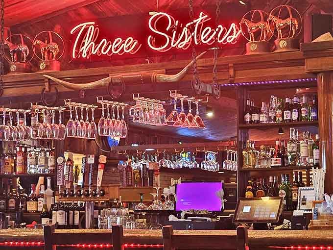 The bar at Three Sisters gleams with promise, stocked like someone actually cares about your drinking experience tonight.