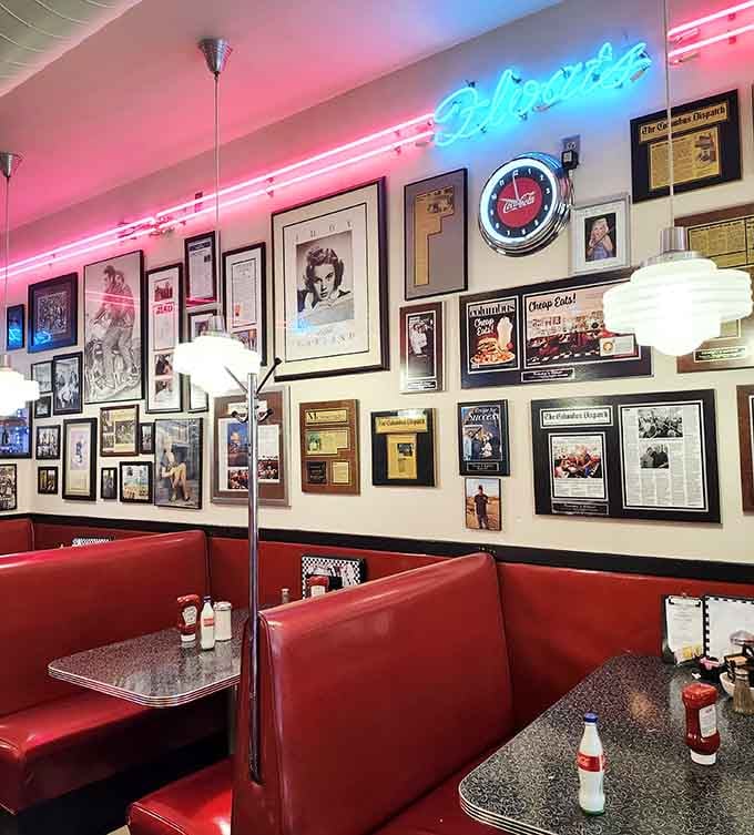 Classic booth seating lined with decades of memories on the walls, where every frame tells a story worth hearing over coffee.