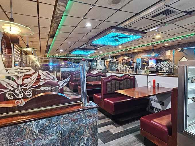 Burgundy booths stretch invitingly through the space, each one ready to host your next memorable meal together.