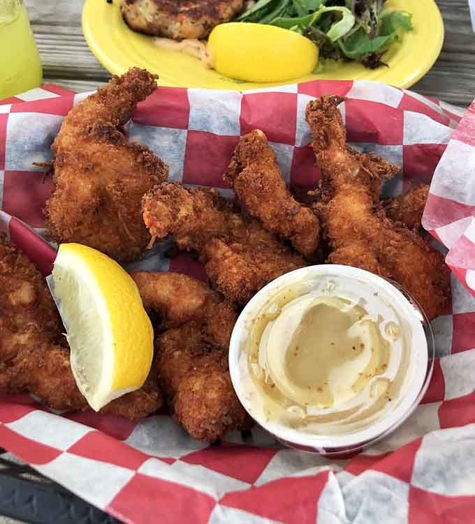 Coconut shrimp arrives golden and crispy, looking like tiny tropical treasures that won't last five minutes.