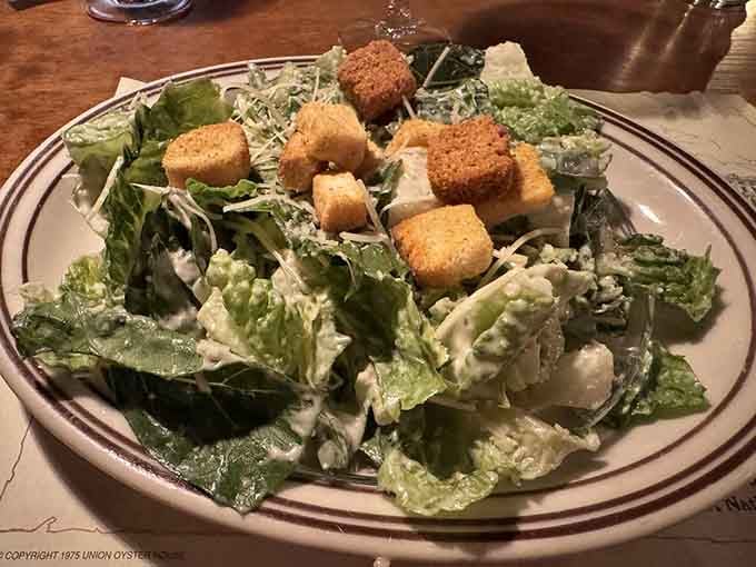 Even the Caesar salad gets the historic treatment, crispy croutons included for maximum crunch satisfaction.