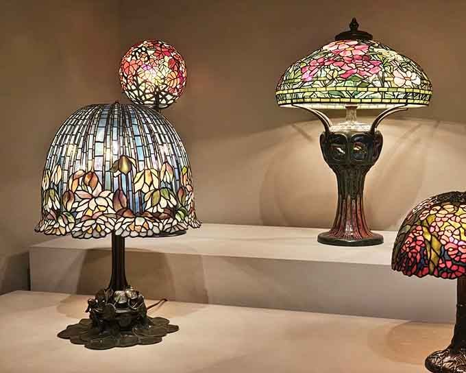 Tiffany lamps glowing like stained glass dreams, making every other lamp you've ever owned feel deeply inadequate about itself.