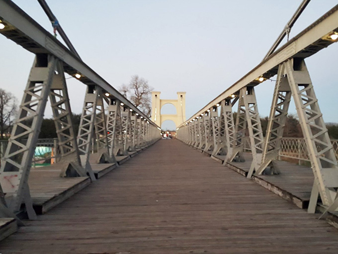 Walking across this boardwalk bridge feels like stepping into a postcard you'd actually want to receive.