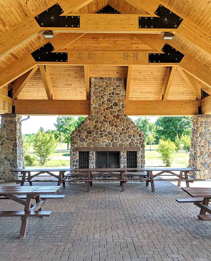 This pavilion's stone fireplace and timber beams say rustic elegance louder than any interior designer's mood board ever could.