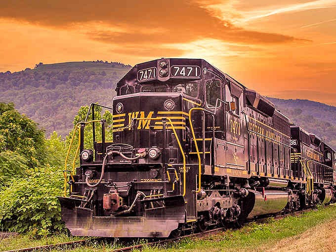 Golden hour hits different when mountains frame the shot and locomotives add that perfect touch of Americana nostalgia.