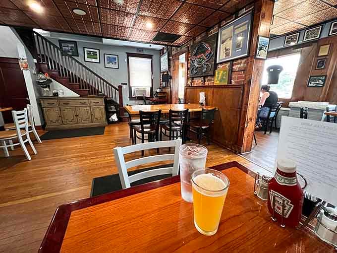Tin ceiling tiles and wooden accents create that perfect blend of rustic charm and comfortable coastal dining atmosphere.