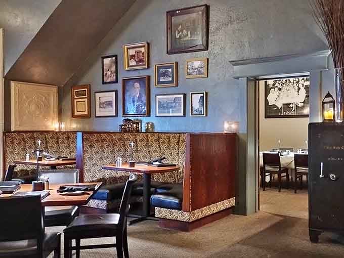 Booth seating with patterned upholstery and framed photos creates an atmosphere that's both elegant and welcoming.