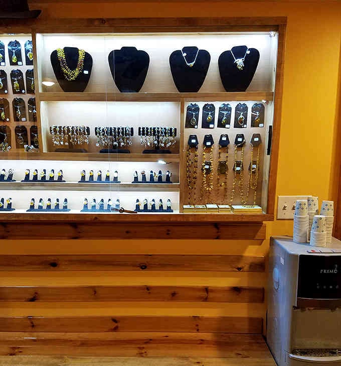 Handcrafted jewelry displayed in illuminated cases adds a touch of elegance to this holistic wellness destination's retail offerings.