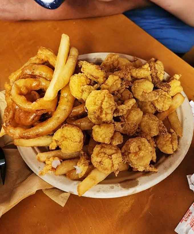Plump shrimp with rings and fries, creating a fried seafood trifecta that dreams are made of.