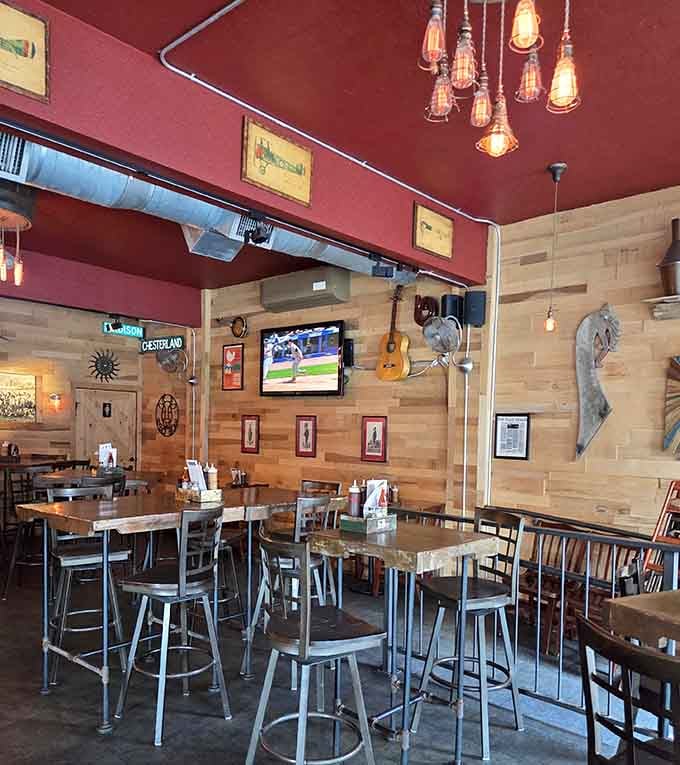 Exposed ductwork and Edison bulbs create an industrial-chic atmosphere where comfort food meets contemporary design sensibilities beautifully.