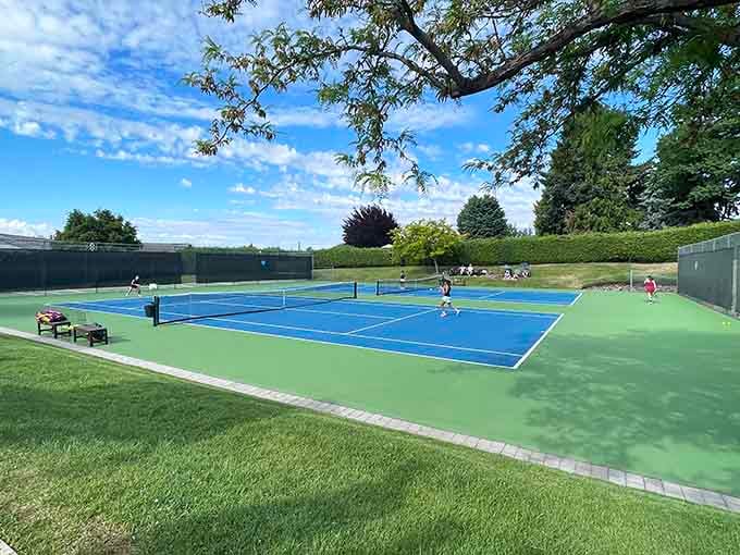 Yakima Tennis Club's pristine courts offer recreation under sunny skies, membership fees refreshingly reasonable compared to Seattle.