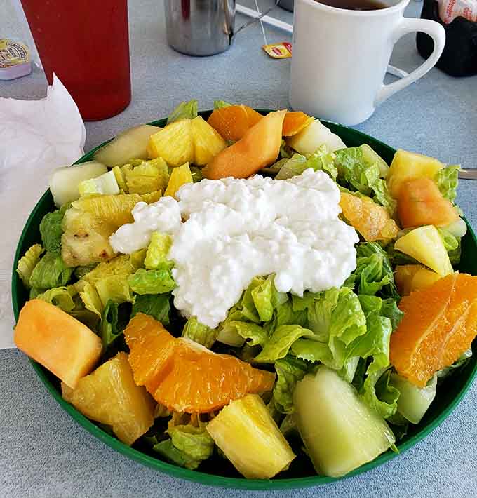 Even the salads come loaded with cottage cheese, fruit, and enough toppings to require strategic planning.