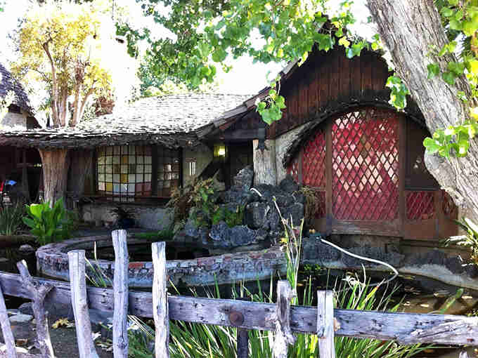 This rustic retreat with its koi pond and latticed gate looks like it grew organically from the earth.