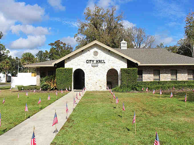 American flags line the walkway to City Hall, showing small-town pride that never goes out of style.