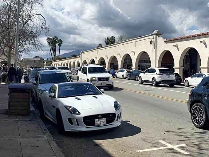Dramatic clouds gather over Spanish colonial arches where even the weather seems to put on a show.