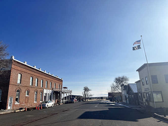 The brick hotel stands sentinel on this quiet street where tumbleweeds have more appointments than most residents.