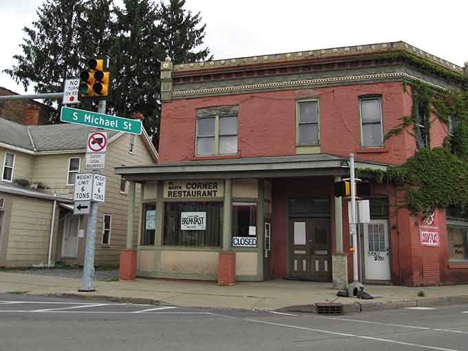 Corner restaurant sits quietly at the intersection, its vintage signage promising home-cooked meals and conversations with friendly locals.