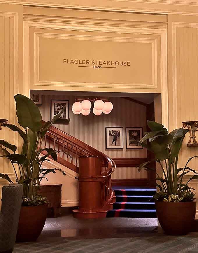 Warm lighting illuminates the grand entrance where polished wood and vintage charm promise an exceptional evening ahead.