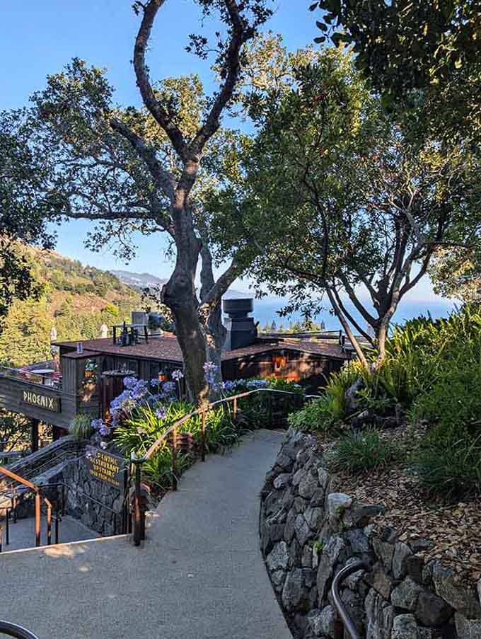 The garden pathway winds through purple flowers toward ocean views that'll take your breath away before lunch does.