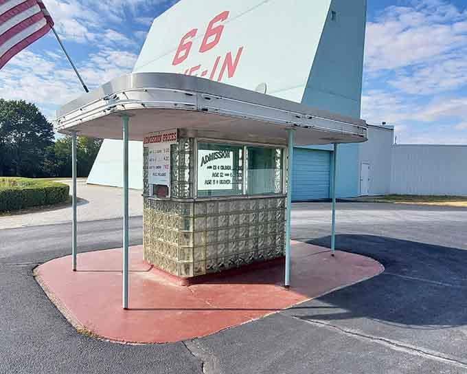 The admission booth's glass block construction and curved metal canopy showcase the architectural optimism of America's drive-in heyday.