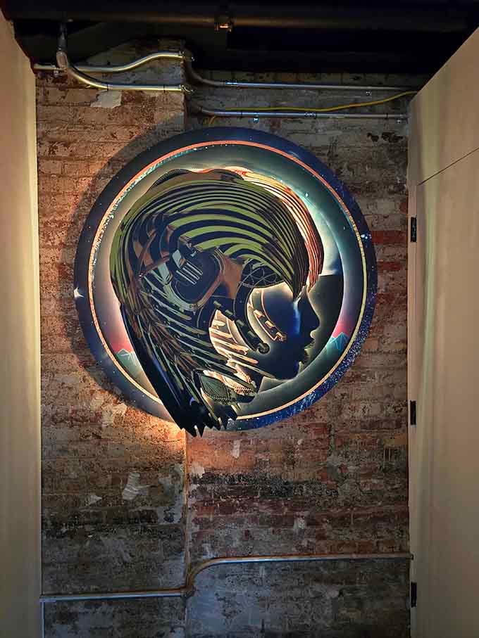 Metallic sculptures spiral inward, catching reflections that multiply the visual feast happening all around the space.