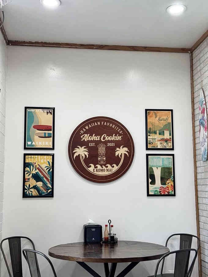 Vintage travel posters and a classic Aloha Cookin' sign create atmosphere without overdoing the tropical theme.