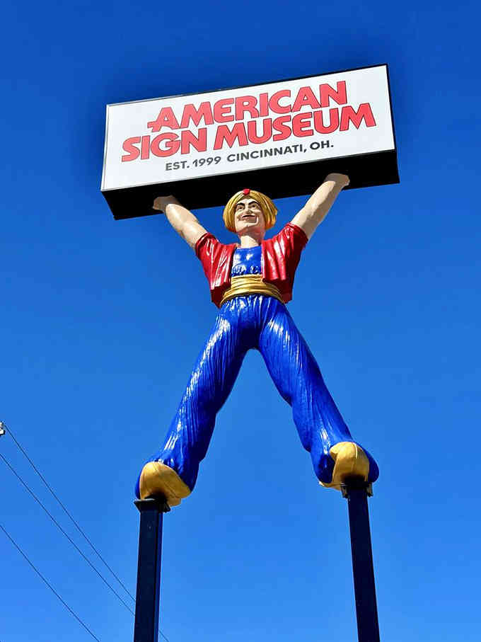 This towering figure literally holds up the museum's name, welcoming visitors with arms spread wide in pure joy.