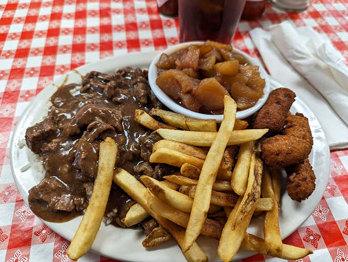 Tender beef tips with gravy, fries, apples, and hush puppies, lunch done the right way.