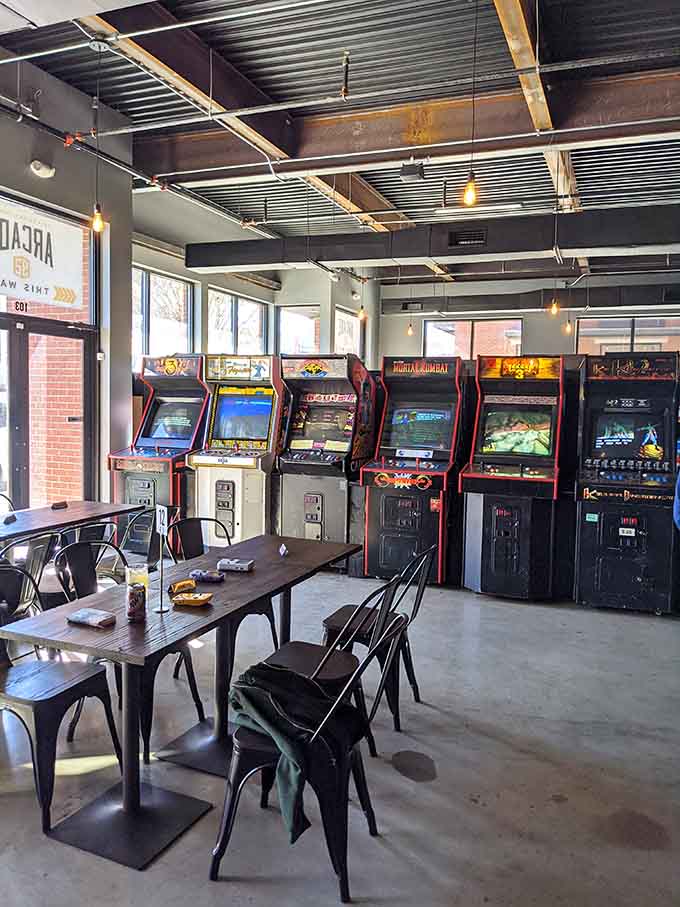 Natural light streaming through windows illuminates a perfect blend of dining space and gaming paradise for daytime adventures.
