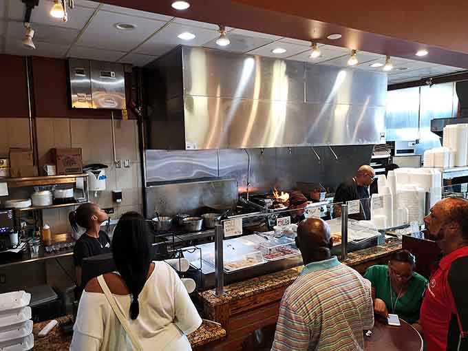 That gleaming kitchen setup shows serious commitment to the craft, where barbecue artistry happens in plain sight daily.