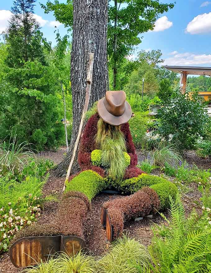 A topiary gentleman tips his hat to passersby, proving that good manners never go out of style, even in plant form.