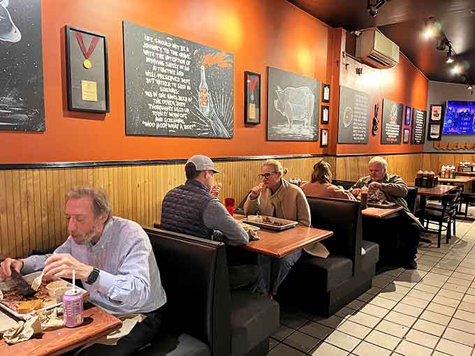 Booth seating filled with happy diners who've clearly made peace with getting sauce on their shirts.