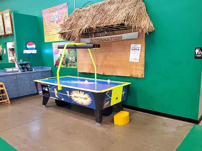 Air hockey under a tiki hut is exactly the kind of delightful contradiction that makes this place special.
