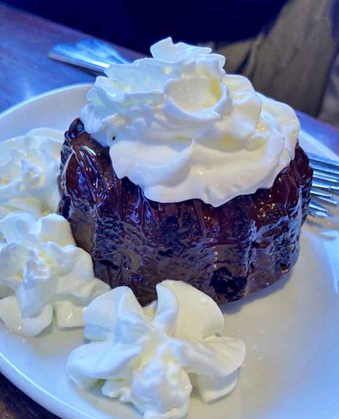 Rich chocolate lava cake topped with whipped cream provides the sweet ending your seafood feast absolutely deserves.