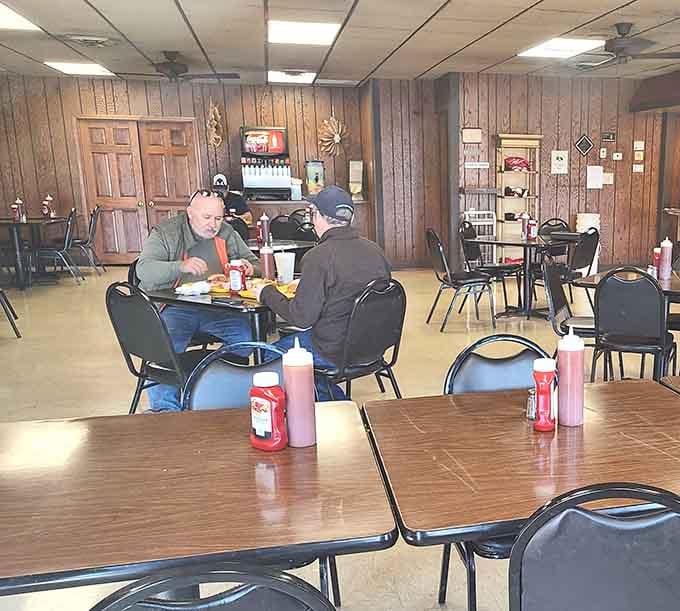Simple tables, simple chairs, and absolutely nothing simple about the incredible barbecue being devoured here with pure joy.