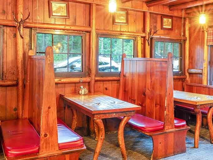 Booth seating with red cushions and knotty pine walls delivers that classic American diner experience in the mountains.