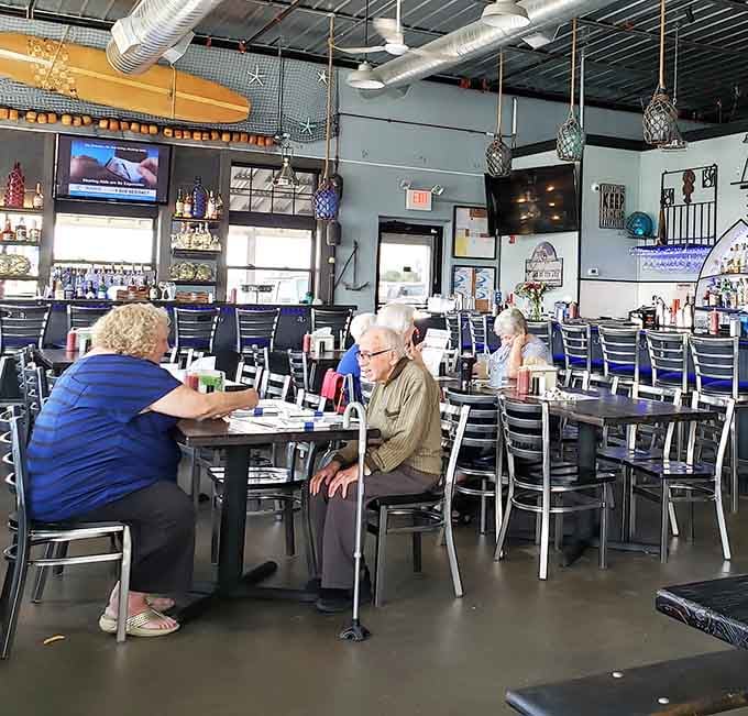 Diners enjoying their meals in the relaxed atmosphere where good food and conversation flow as freely as the harbor views.