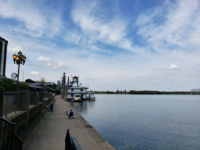 The riverfront walkway offers perfect views of the Belle at rest, a preview of the adventure waiting just beyond that gangplank.